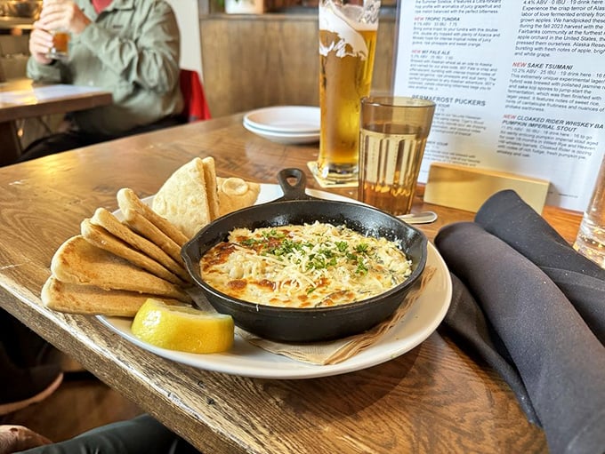 This crab artichoke dip, bubbling in its cast iron skillet, has started more friendships than Facebook ever could.