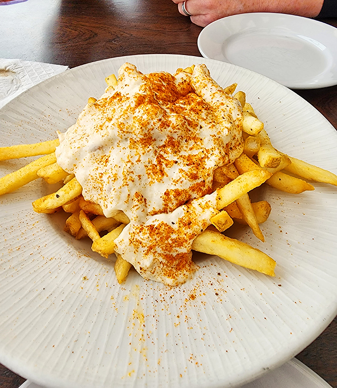 Crabby fries&mdash;where French fries decided to dress up for a night out, donning a creamy crab-infused topping that makes ketchup jealous.