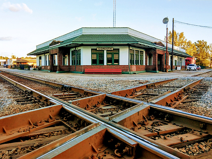 The historic Corinth depot, where railroad tracks cross like destinies, now houses the Crossroads Museum instead of waiting passengers.
