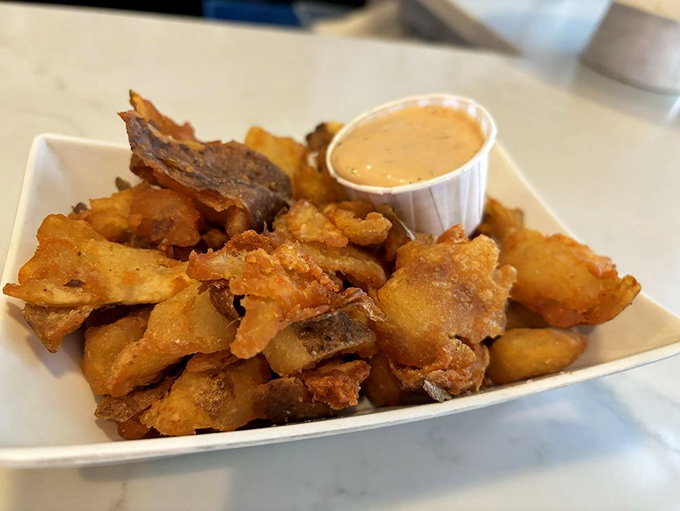 Crushed potatoes that look like they've been kissed by the deep fryer gods. That dipping sauce is the wingman these golden nuggets deserve.