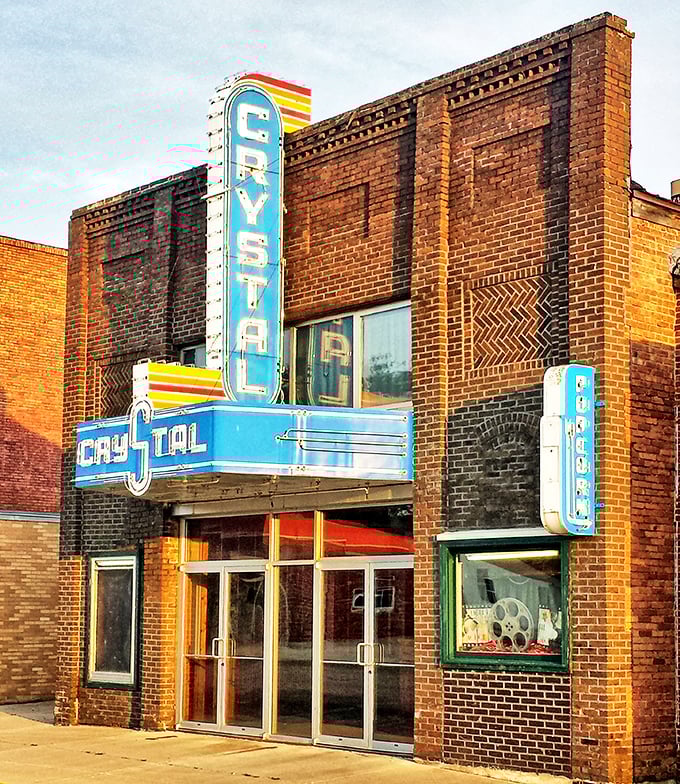 The Crystal Theatre's Art Deco fa&ccedil;ade glows warm in evening light, a cinematic experience before you even buy popcorn.