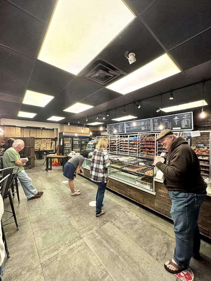 The contemplative stance of donut selection requires focus, strategy, and accepting you'll probably regret not buying more.