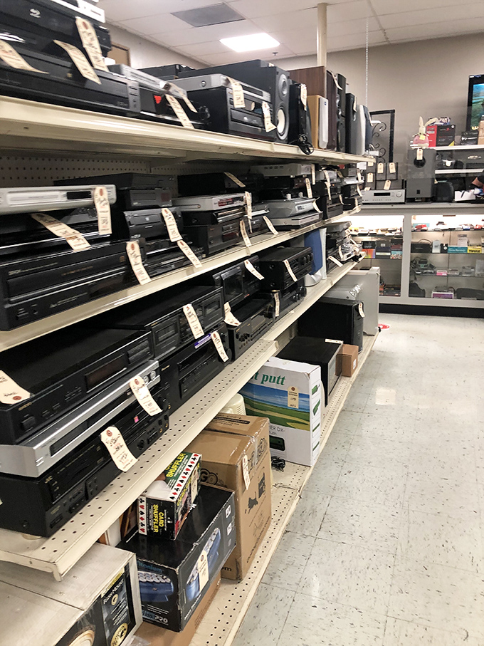 A tech graveyard or vintage audio paradise? These shelves of DVD players and stereo equipment await their second act in someone's home.