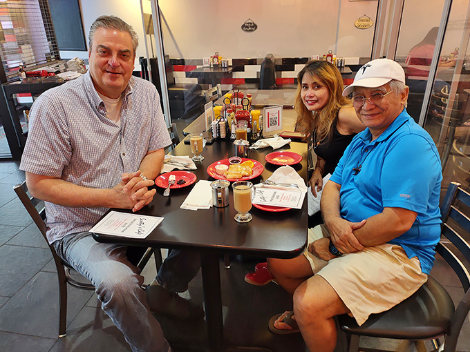 The true measure of any great diner: happy patrons engaged in that sacred ritual of good food and better conversation.