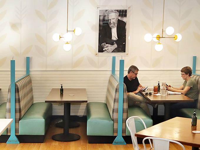 Cozy booth seating where breakfast dreams come true. The plaid upholstery and mid-century lighting create the perfect backdrop for morning conversations.