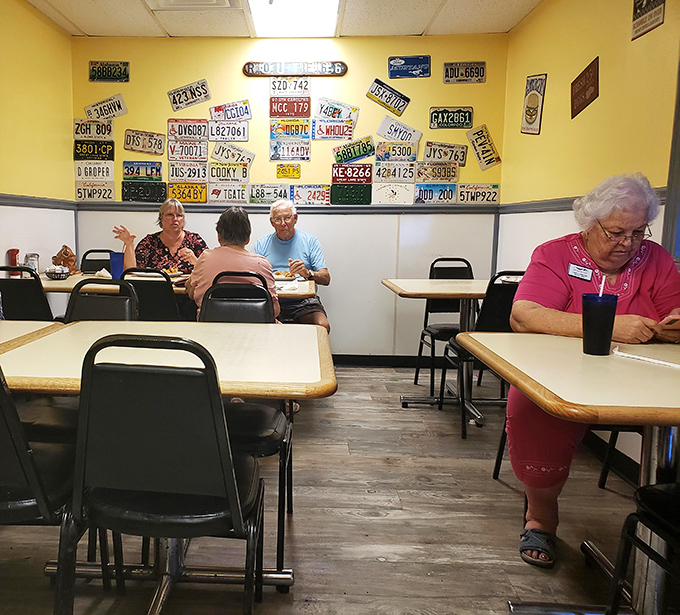 The license plate wall watches over diners like a gallery of travelers who found their way to this breakfast sanctuary.
