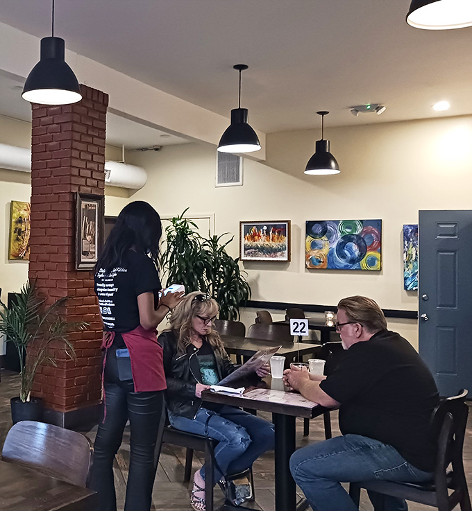 The dining room hums with the energy of satisfied customers, where strangers become temporary family united by the universal language of good food.