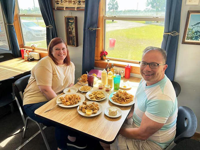 Happy diners surrounded by a feast fit for Neptune himself. The table tells the story: this is a place worth bringing friends.