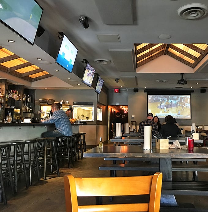 The bar area isn't just serving drinks—it's creating the perfect backdrop for the "I'll just have one more" lies we tell ourselves when the barbecue's this good.