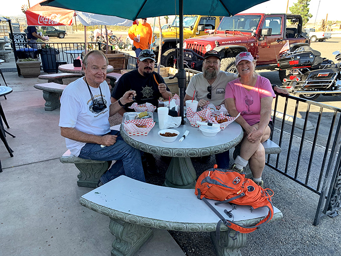 The outdoor patio at Cafe 247 turns strangers into friends, united by red baskets, checkered paper, and the universal language of "pass the ketchup."