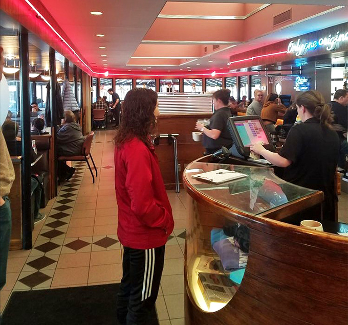 Where strangers become temporary friends united by the universal language of "pass the ketchup." Drake Diner's bustling interior at peak hours.