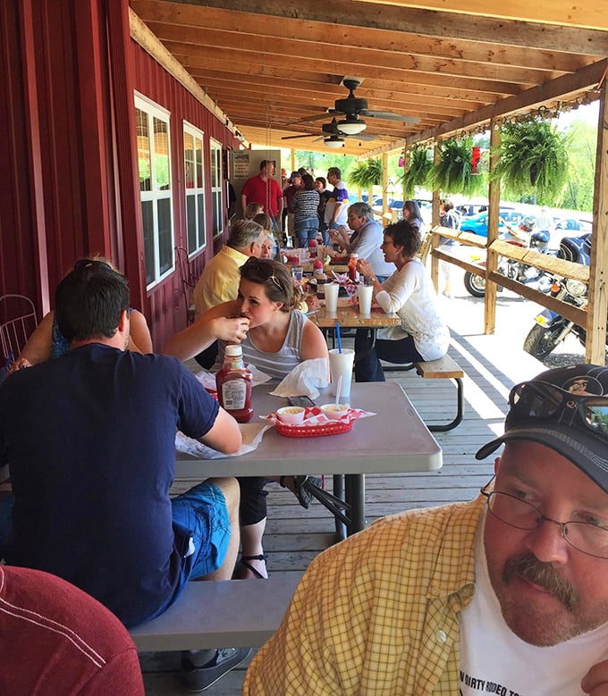 The covered porch – where strangers become friends over sauce-stained fingers and shared barbecue epiphanies. Southern hospitality in its natural habitat.