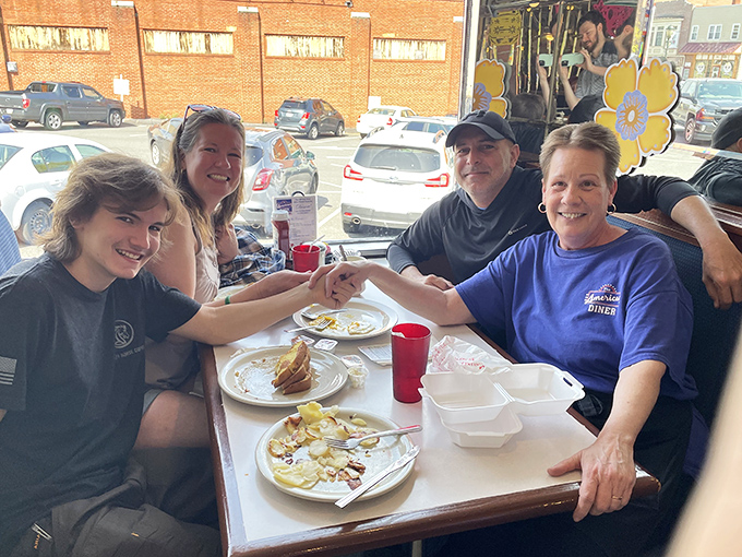 Happy diners sharing a moment over empty plates—the universal sign of meal satisfaction. Their smiles tell you everything you need to know about the food.