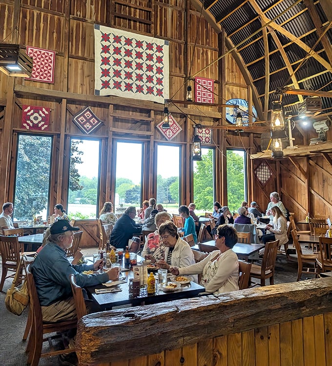 Quilts adorn wooden walls while diners enjoy hearty meals beneath soaring rafters. Norman Rockwell couldn't have painted a more quintessential American scene.