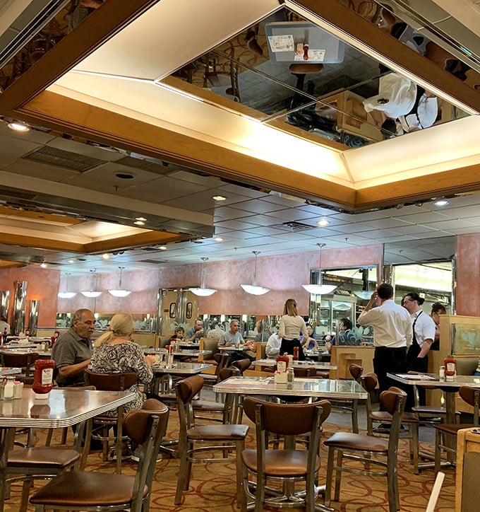 The mirrored ceiling reflects more than just diners—it captures decades of late-night conversations, first dates, and the timeless ritual of breaking bread together.