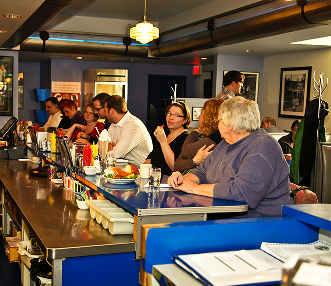 The counter is where the magic happens. Regulars and first-timers alike find common ground in the universal language of "pass the ketchup, please."
