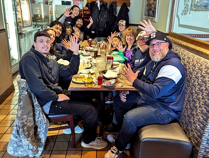 Happy diners raising hands like they just won sandwich bingo &ndash; and honestly, they kind of did.