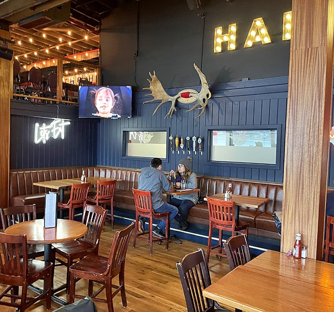 The navy blue walls adorned with local touches create the perfect backdrop for conversations that flow as easily as the drinks.