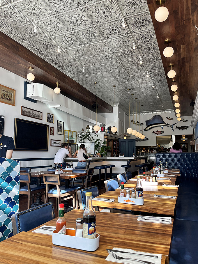 The dining room feels like the captain's quarters of a particularly stylish ship, where pressed tin ceilings meet maritime memorabilia and comfortable navy banquettes.