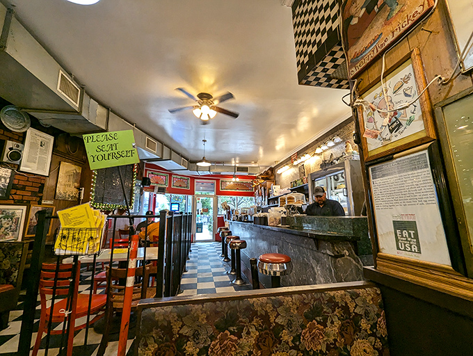 The ceiling fans spin stories overhead while the "Please Seat Yourself" sign offers the most New York welcome imaginable.