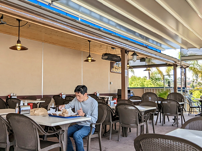 The covered patio dining area &ndash; where paper plates meet million-dollar views and nobody complains about either.
