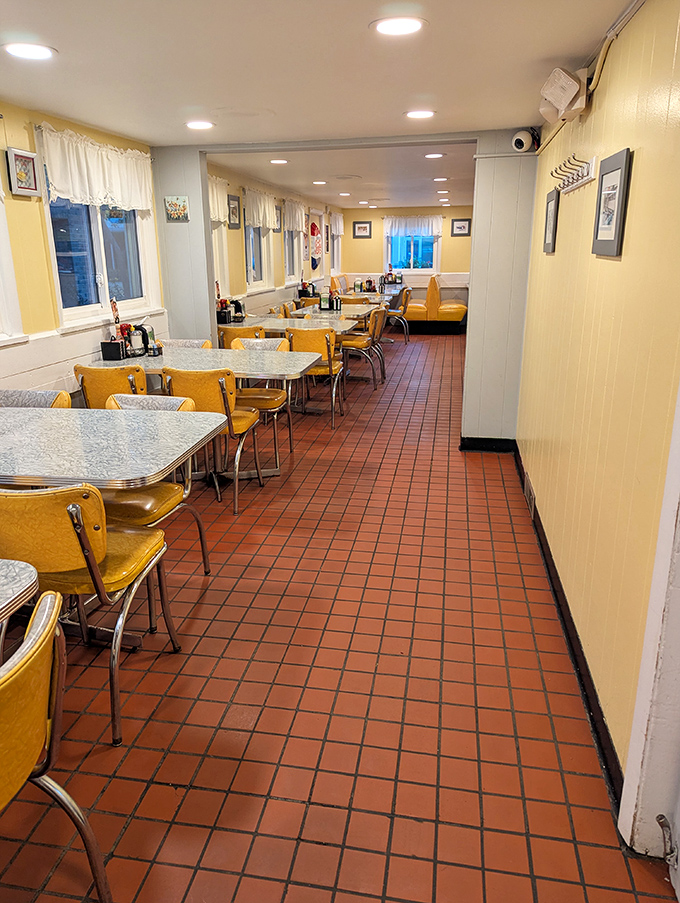 The dining area's warm yellow glow invites you to settle in. Where strangers become neighbors and calories become memories.