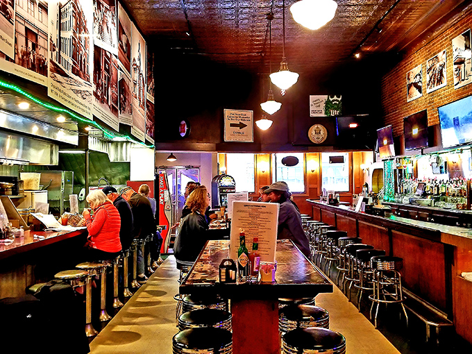 The classic diner setup with its worn bar top and vintage ceiling tells stories of countless meals and conversations shared over decades.
