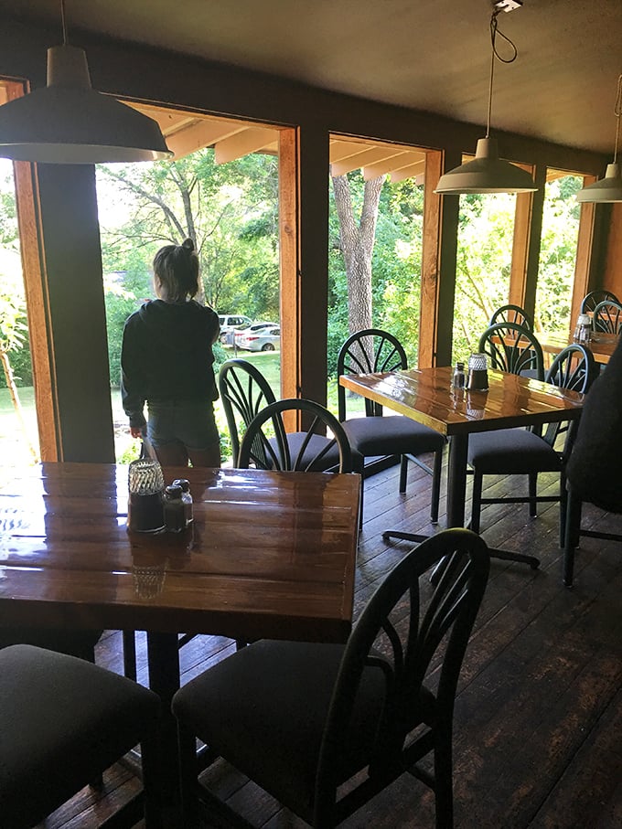 Large windows frame nature's artwork while diners enjoy the rustic charm inside – it's dinner with a view that soothes the soul.