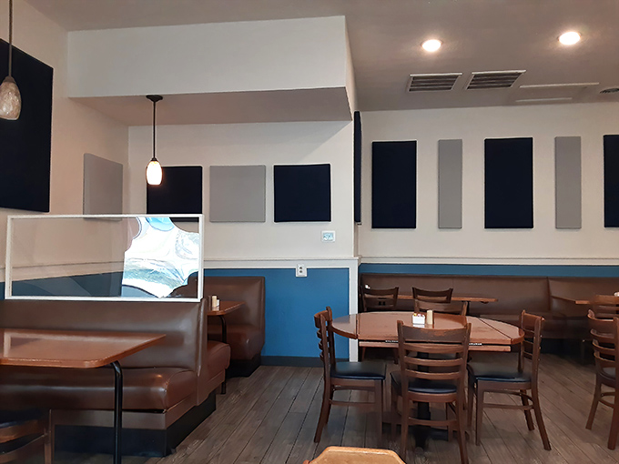 The dining area's blue accents and comfortable booths invite you to settle in, loosen your belt, and stay awhile.