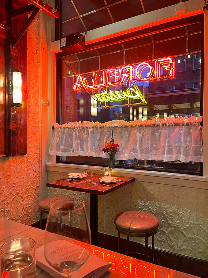 The warm glow of neon transforms this corner table into the most romantic spot in Philadelphia. Even the curtains seem to flutter with Italian passion.