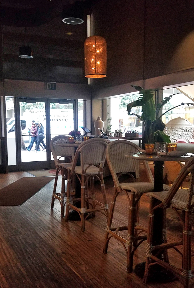 Modern meets cozy in this unexpected dining space, where every table has a front-row seat to neighborhood life.