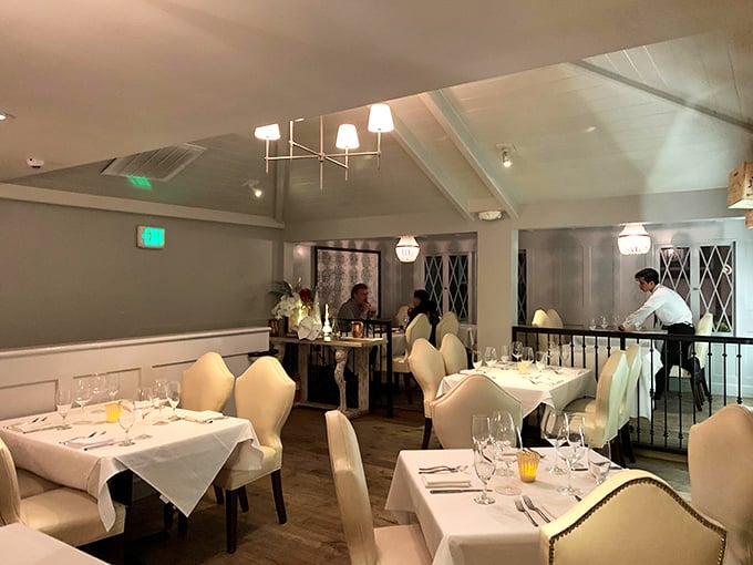 The upstairs dining area combines coastal elegance with intimate comfort&mdash;like dining in a stylish friend's beach house, if your friend were a culinary genius.