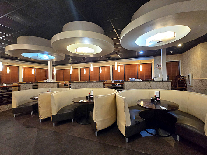 The modern dining area features cream-colored booths beneath UFO-like ceiling fixtures, creating an atmosphere that says "stay awhile" rather than "eat and run."