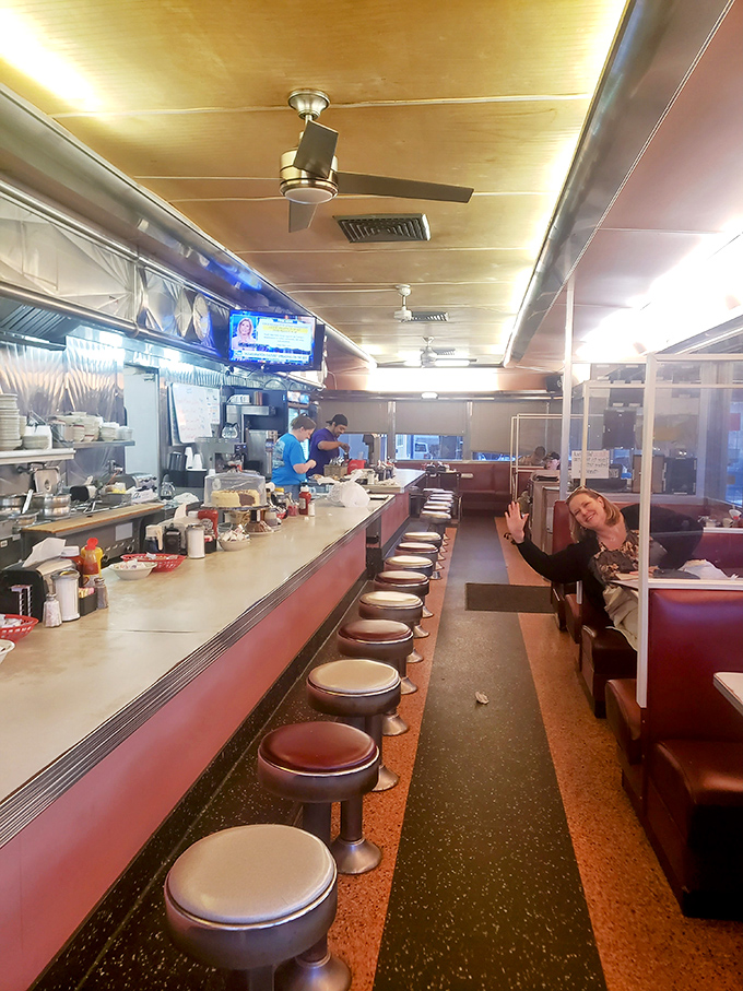 The long counter stretches like a runway where breakfast dreams take flight, one swivel stool at a time.