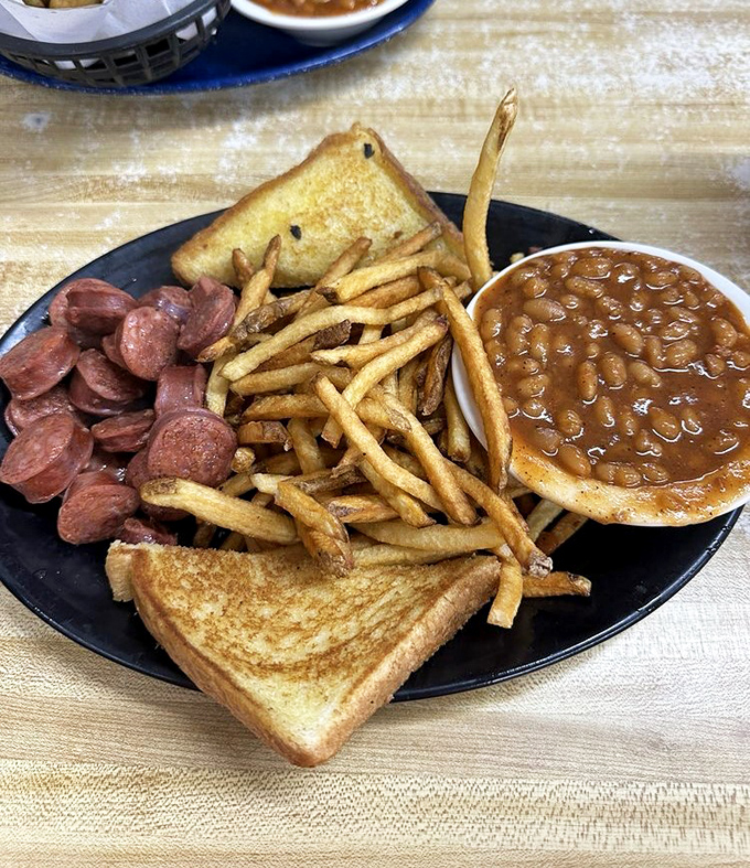 The perfect BBQ plate doesn't exi&mdash; Oh wait, here it is: smoky links, golden toast, crispy fries, and beans rich enough to be a meal.