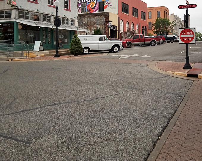 East Commerce Street's vintage vehicles and historic buildings create an accidental movie set where everyday life feels like a period piece.