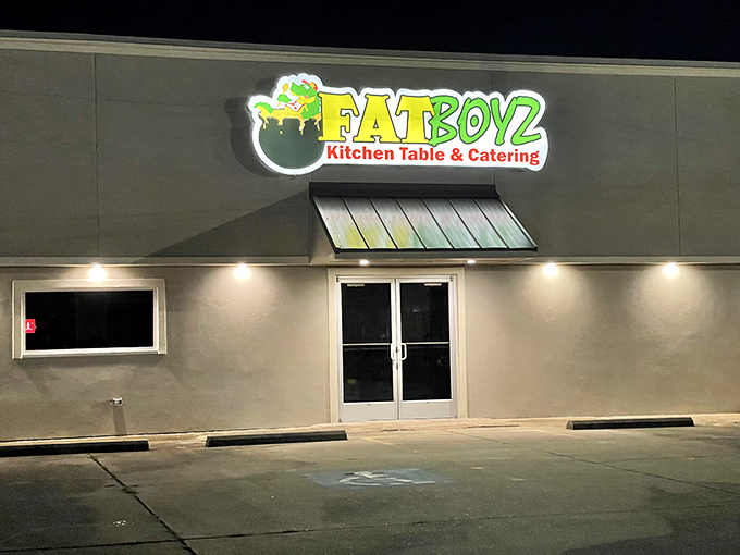 Fatboyz Kitchen Table's glowing sign promises the kind of meal that requires both a fork and a nap afterward. Diet plans come here to die happily.