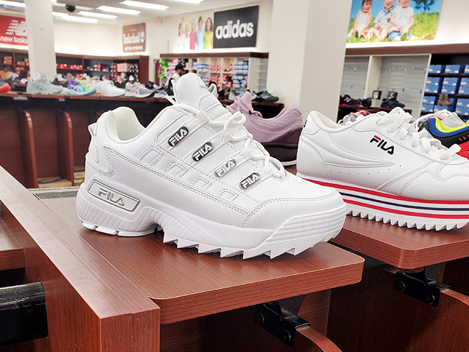 White Fila sneakers waiting for their forever homes. At outlet prices, the "one pair or two?" question becomes dangerously easy to answer.