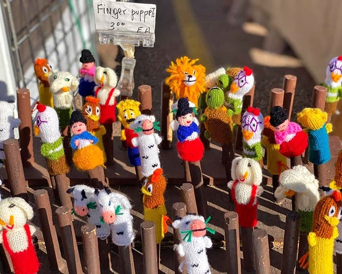 Knitted finger puppets standing at attention, ready to entertain grandkids or become the world's cutest desk decorations.
