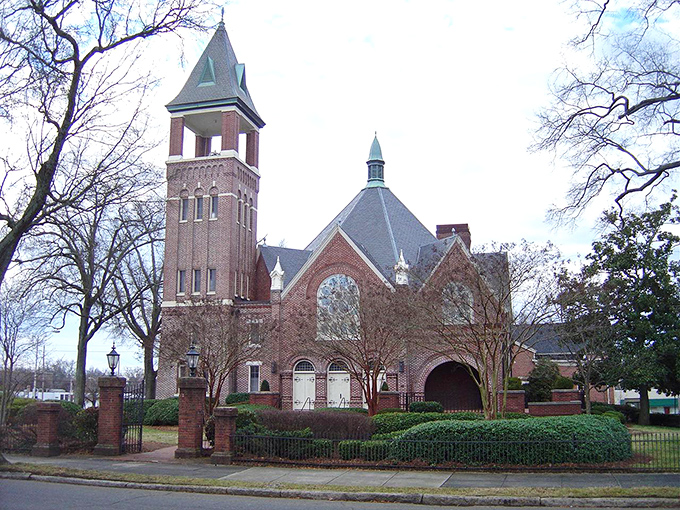 First Presbyterian's magnificent tower reaches skyward like the community's aspirations, its brick and mortar a testament to enduring faith and craftsmanship.