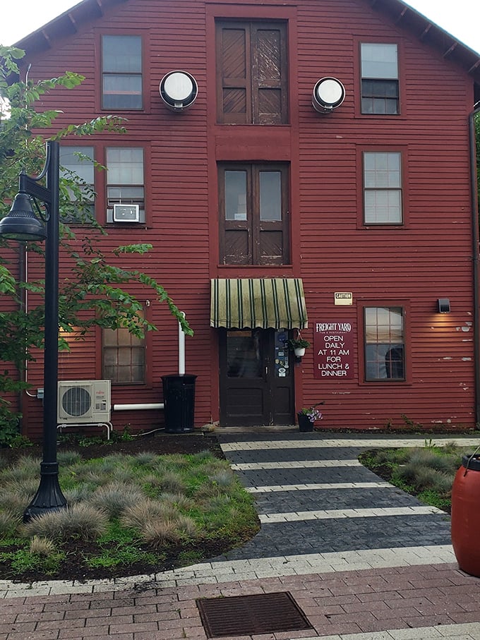 The Freight Yard Pub's rustic red exterior promises comfort food with a side of history—this former railroad building now serves journeys of the culinary kind.