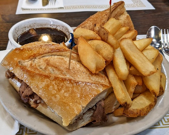 A French dip sandwich that demands respect &ndash; golden bread, tender meat, and those fries standing at attention like delicious potato soldiers.