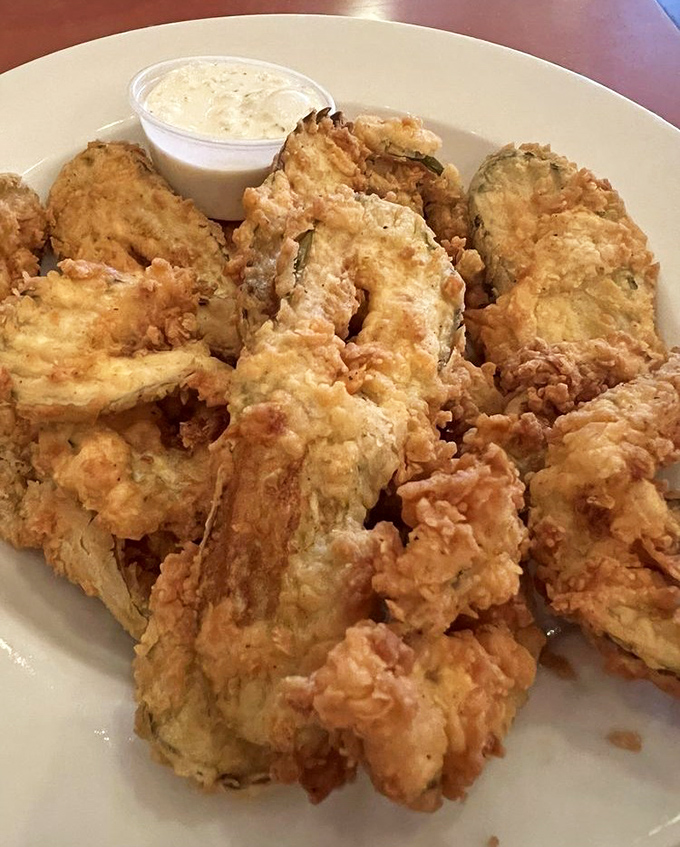 Fried chicken that crackles when your fork touches it. The batter holds secrets that corporate chains have spent millions trying to duplicate.