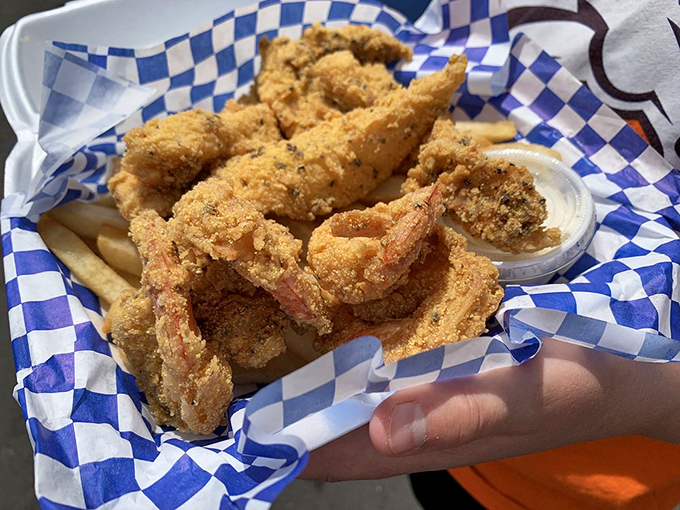 Fried catfish and shrimp wearing golden cornmeal jackets, ready to dive into that tartar sauce for a swim party in flavor town. 