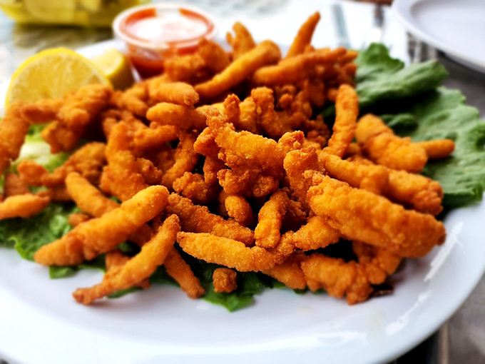 These golden-fried clams aren't just food &ndash; they're little crunchy treasures from the sea, begging to be dunked in that tangy sauce.