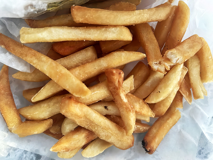These aren't just any fries—they're the perfect hot dog sidekick, crisp outside and fluffy inside, ready for ketchup (which is allowed here).