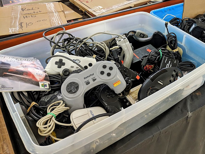 Vintage game controllers in a bin transport you back to simpler times when blowing on cartridges actually solved problems.