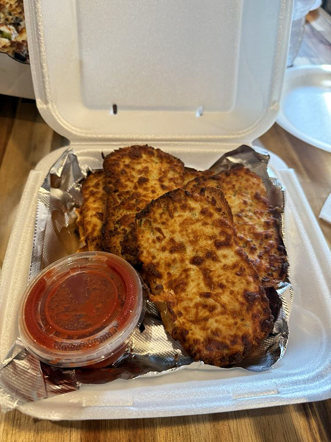 Garlic bread that demands respect. These cheese-topped slices come with marinara for dipping—a combination that should be protected by national heritage laws.