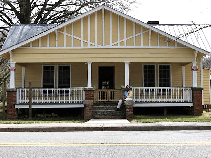 This charming yellow bungalow with its welcoming porch practically whispers "come sit a spell" in the most delightful Southern accent imaginable.