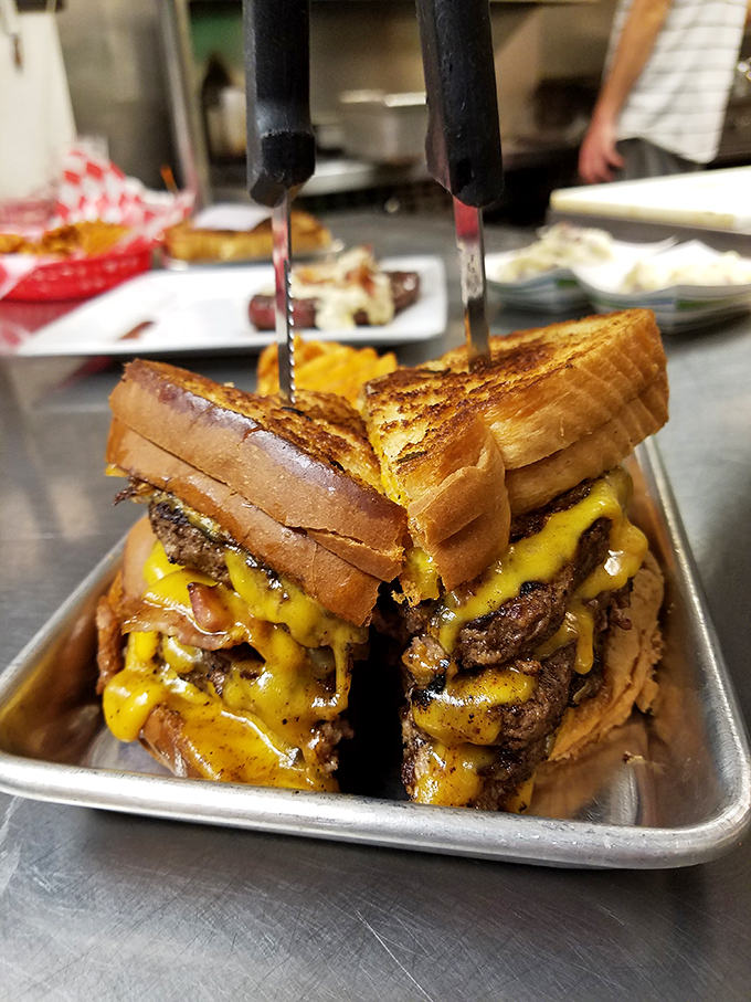 This isn't just a burger; it's a skyscraper of beef and cheese that requires both engineering skills and an impressive jaw span.